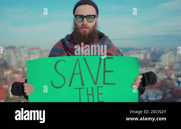 Portrait bearded man activist with Save the Planet ecology poster view ...