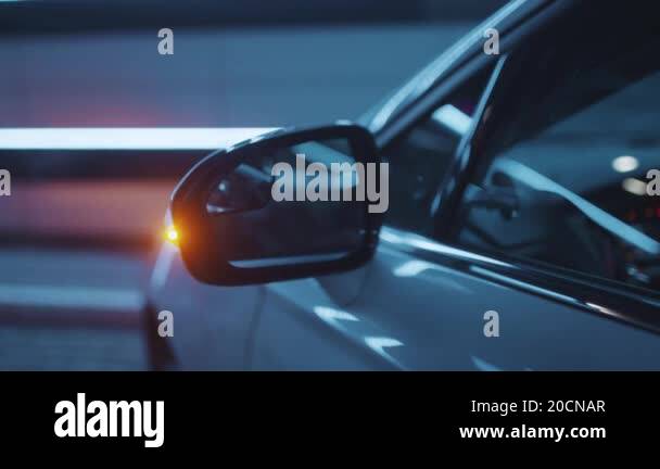 Left side view of parked luxury white new car with flashing lights ...