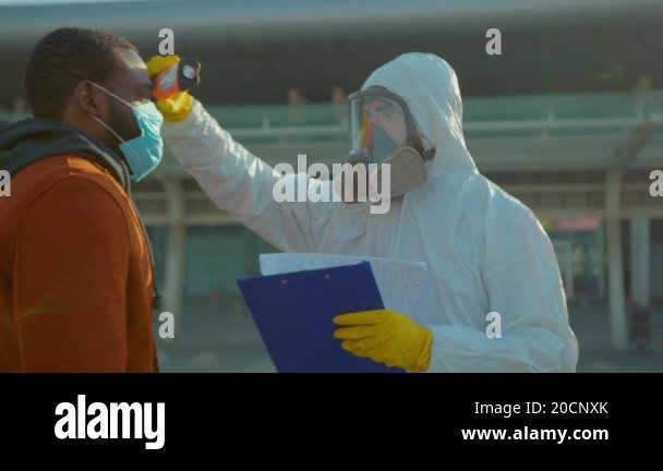 Medical worker screening passengers travellers african american man ...