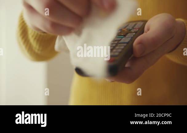 Close-up man holding a remote control washing dirty buttons with ...