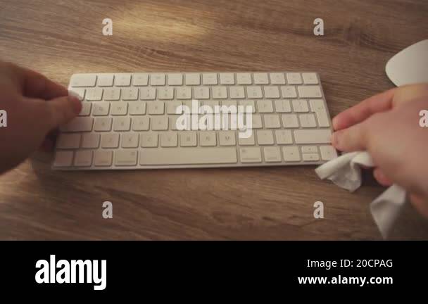 First-person of man washing his office keyboard at desk with ...