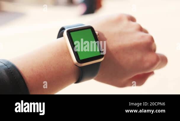 NEW YORK - April 5, 2018:Close up woman hands use smartwatch with green ...