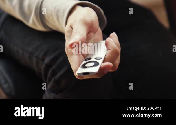 Close up shot of a male hand holding the remote control internet ...