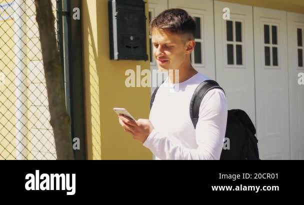 Attractive young man use phone walk on street in city feel happy ...
