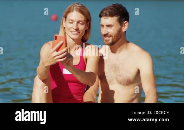 Close up portrait young man and woman is sitting on board use phone ...