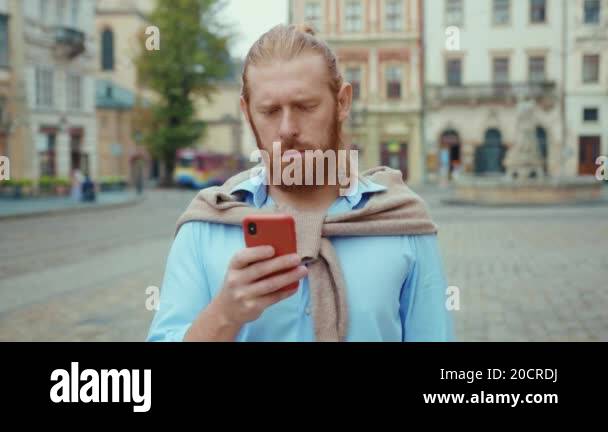 Portrait of confused ginger attractive guy looking confused reading ...