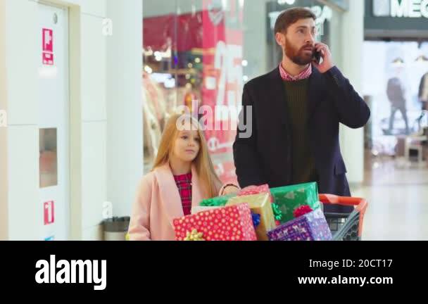 NEW YORK - April 5, 2019: Angry father speak on phone walking with ...