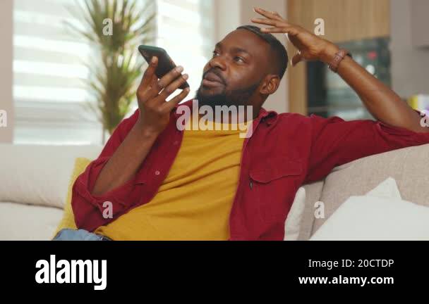 At sunlight african american young man recording voice message use ...