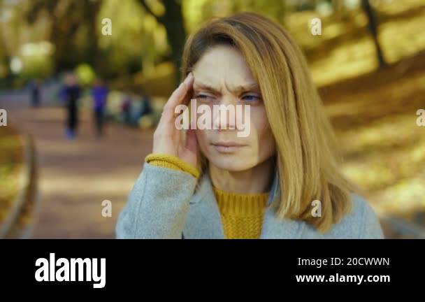 Shot of sick woman having headache feel cold coughs stand look at ...