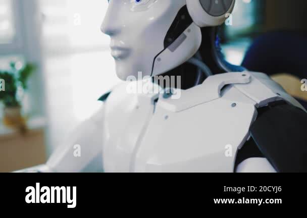 Inside Apartment Cybernetic Robot Working on PC Computer. Indoor ...