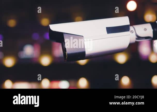 Slow motion security video camera surveillance moving to scan the area ...