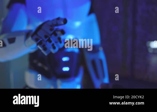 In room with blue light businessman touch finger with a cybernetic ...