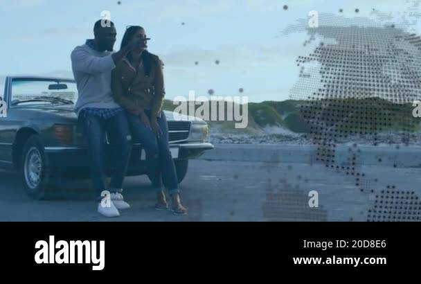 Pointing at something, couple leaning on car with world map animation ...