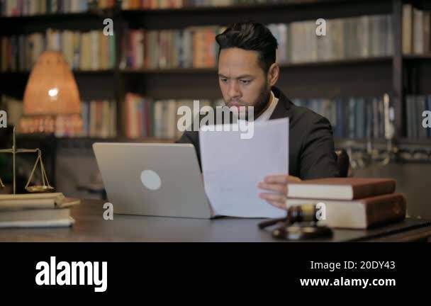 Upset Young Lawyer Shocked while Reading Court Order with Laptop Stock ...