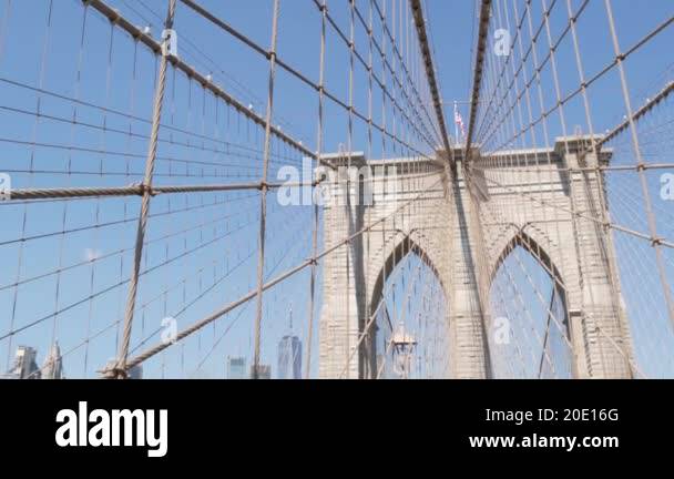 Brooklyn Bridge to Manhattan downtown, cables and blue sky. New York City iconic symbol, USA ...