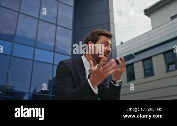 Stressed entrepreneur shouting in cellphone standing urban street ...