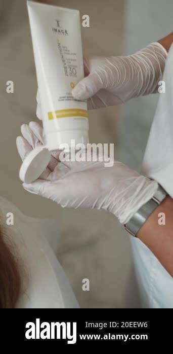 Cosmetologist in Beauty Clinic Applies Moisturizing Cream on Client ...