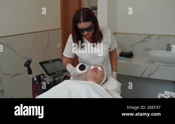 Expert Cosmetologist Conducting Lumecca Skin Renewal Therapy to ...