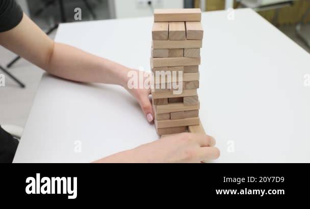 Stacking timber blocks in a complex tower construction project ...