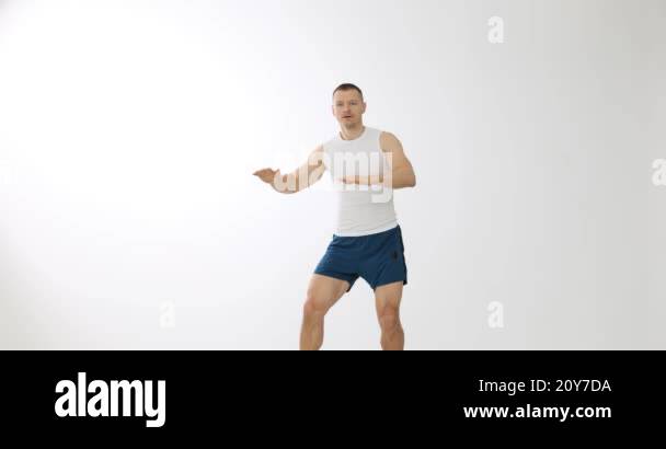 Dance lesson for smiling happy man showing dance moves in white studio ...
