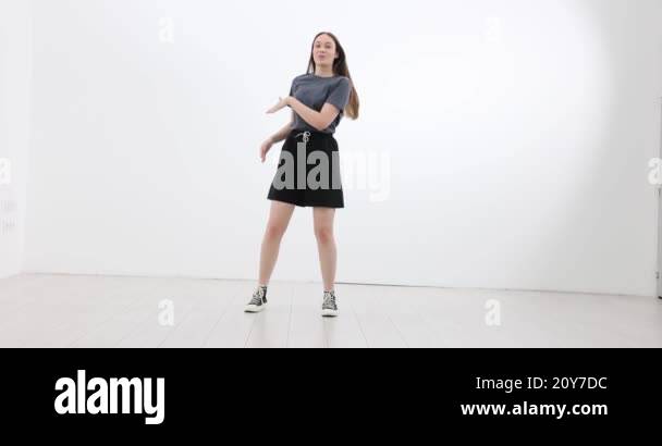 Young woman performing dynamic dance on white background. Dancer ...