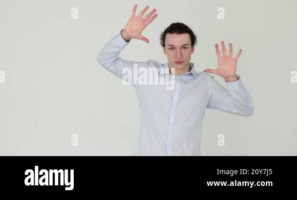 Handsome guy touching invisible wall with his hands. Funny young man ...