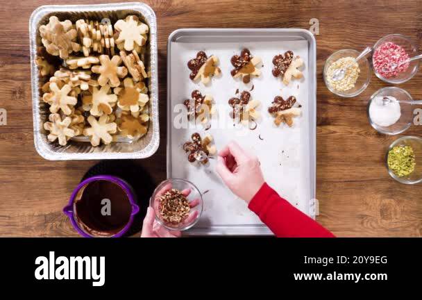 Flat lay. Preparing star-shaped cookies, half-dipped in chocolate ...