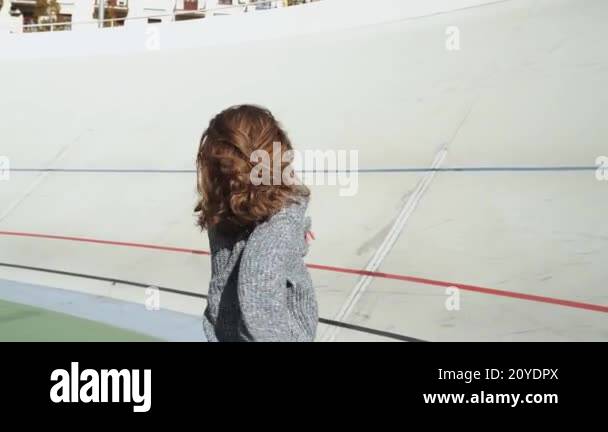 A joyful moment captures a woman twirling freely in an urban setting ...