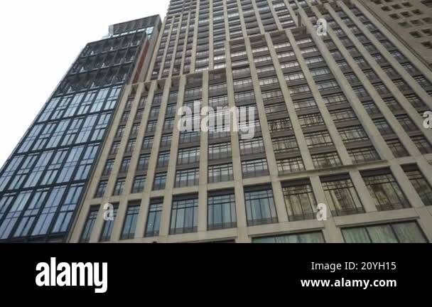 Towering facade of a modern high-rise building with large windows and ...