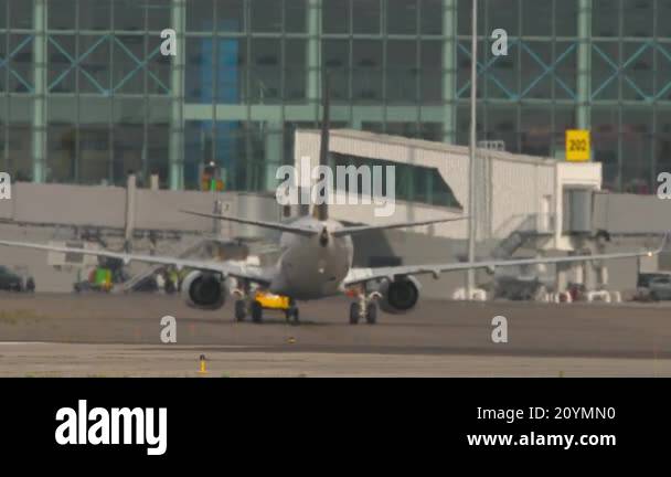 Airplane is taxiing on the taxiway to the airport terminal after ...