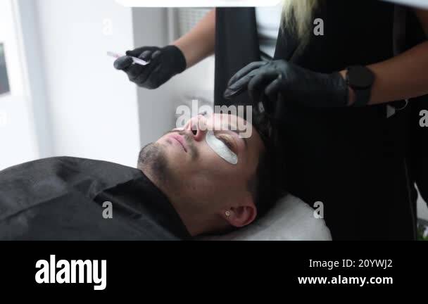 a young guy in an eyelash care salon. The concept of beauty Stock Video ...