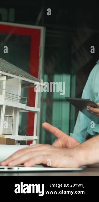 Project manager pointing at house model while discussion about building design. Architect ...
