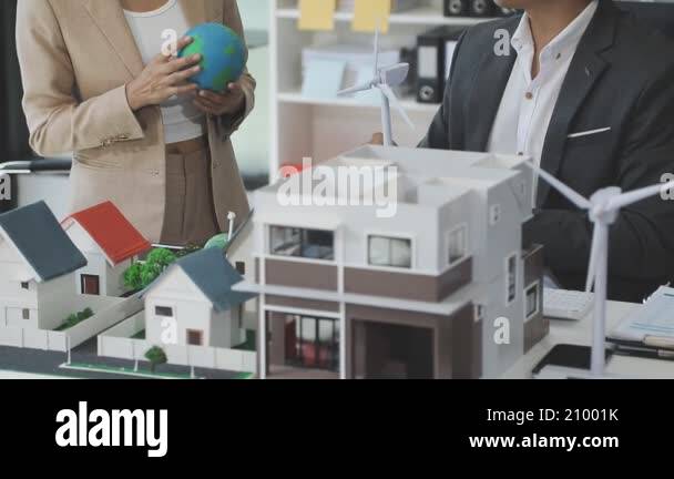 businessman holding house model with models Stock Video Footage - Alamy