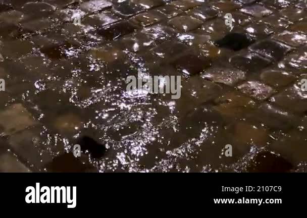 Puddles, streams of water, reflection of light from electric lamps ...