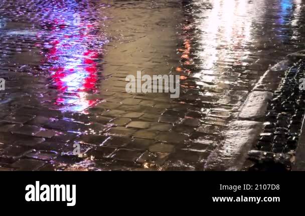 Puddles, streams of water, reflection of light from electric lamps ...