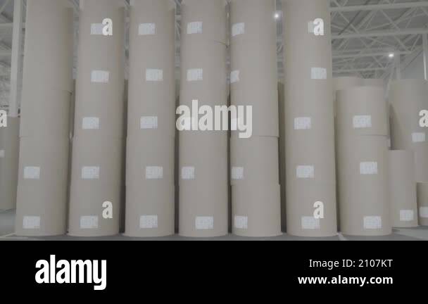 Large cardboard factory warehouse with rolls of labelled paper ...
