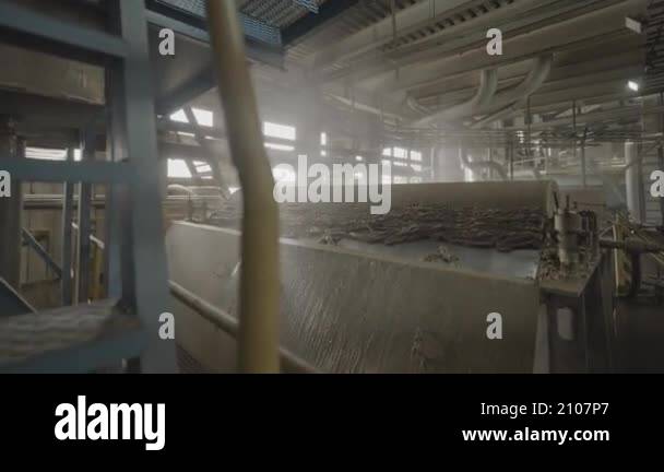 Large paper handling conveyor at cardboard manufacturing plant. Fibers ...