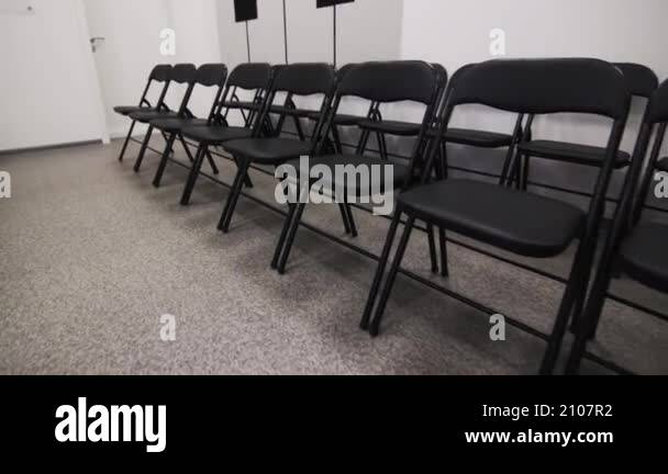 Spectator chairs lined up against wall with piano keys decorations fill ...