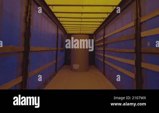 Long truck trailer with finished cardboard roll standing on floor ...