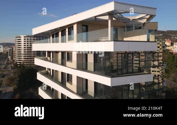 A sleek multi-story building showcases contemporary architecture with ...