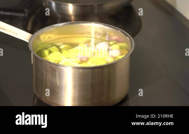 chef expertly adds a splash of water to the sizzling steel cooking pot ...