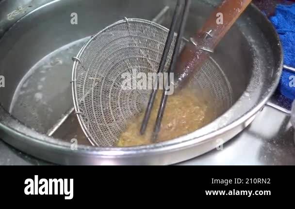 boiled yellow noodle process in big pot at local noodle restaurant ...