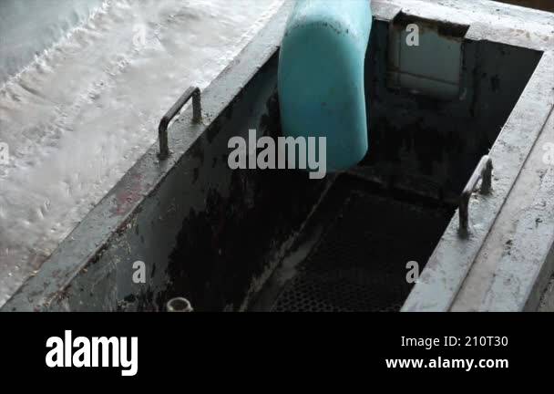 Milky white liquid gush out of the blue plastic industrial water pipe ...