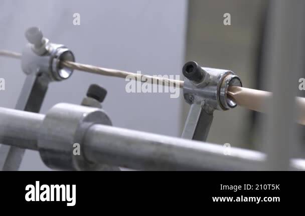 Forming cardboard tube on machine in large factory workshop. Special ...