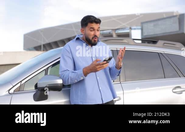 Surprised attractive guy feeling joy, while looking at phone screen on ...