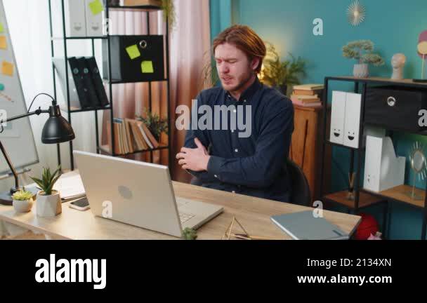 Disappointed Caucasian freelancer feeling overeating during work ...