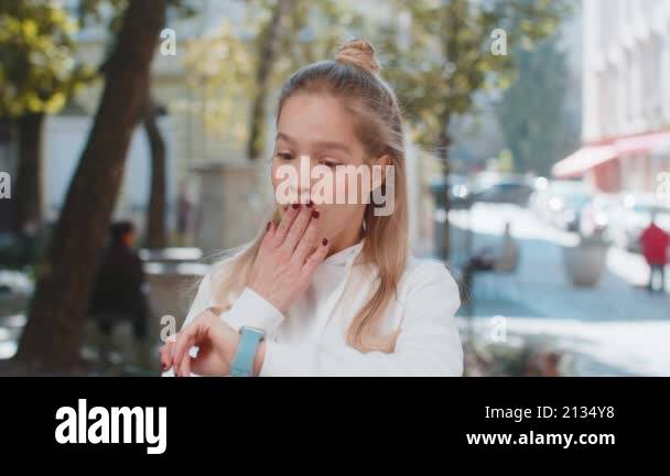 Serious dissatisfied Caucasian woman girl standing outdoors looking for ...