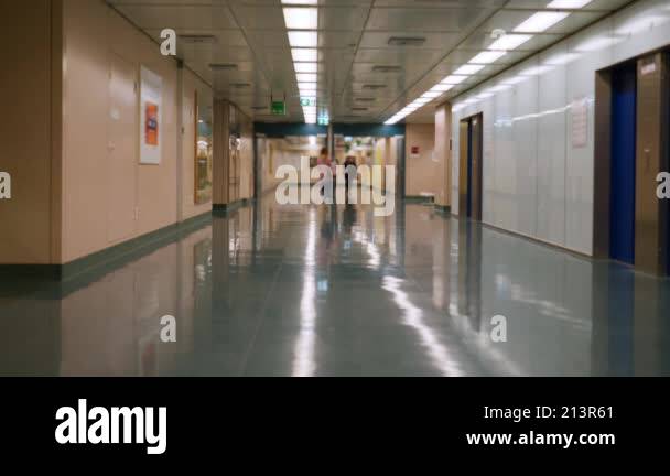 Modern hospital corridor with polished floors and bright lights ...