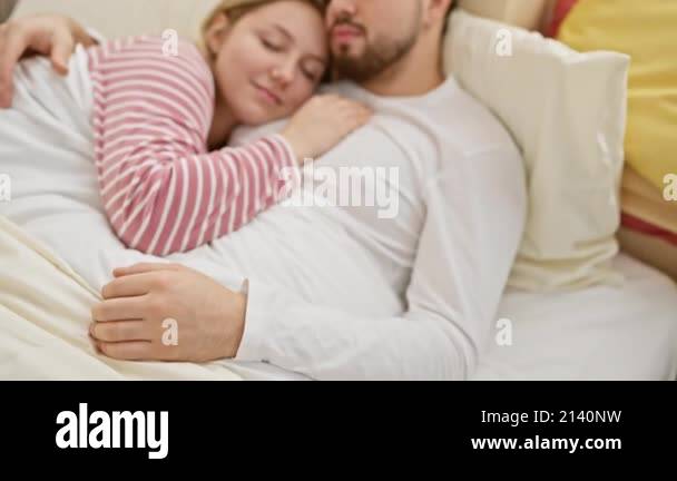 A loving couple peacefully sleeping together in a cozy, well-lit ...