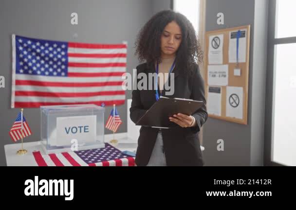 An american woman working as an election official inside a polling ...